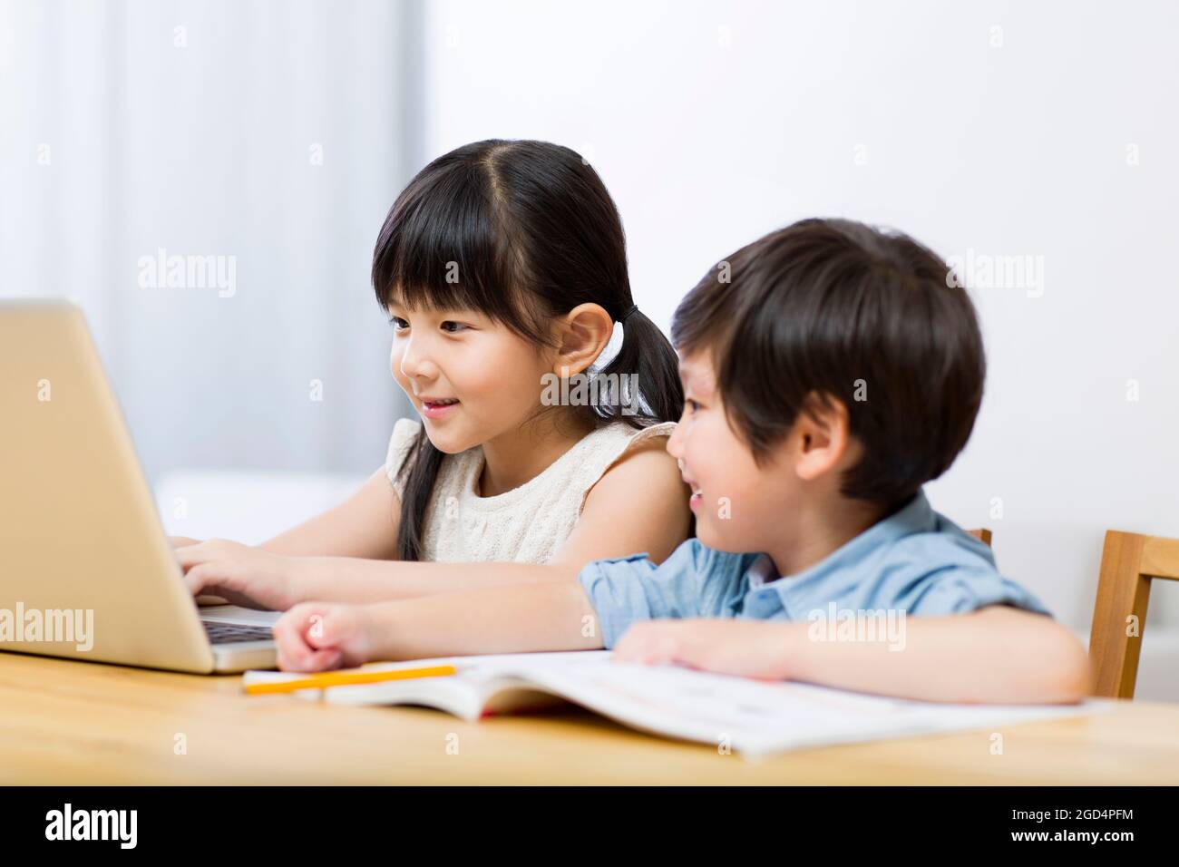 Little boy and girl doing homework Stock Photo - Alamy