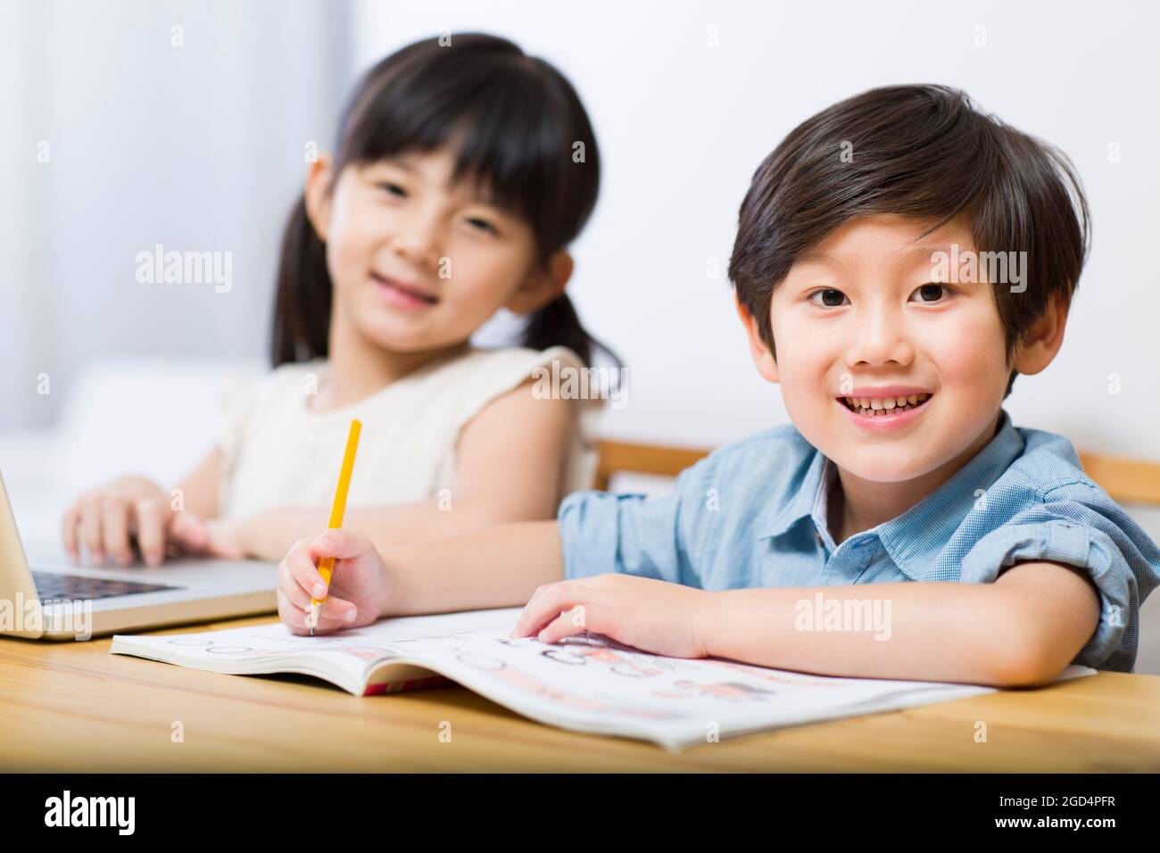 Little boy and girl doing homework Stock Photo - Alamy