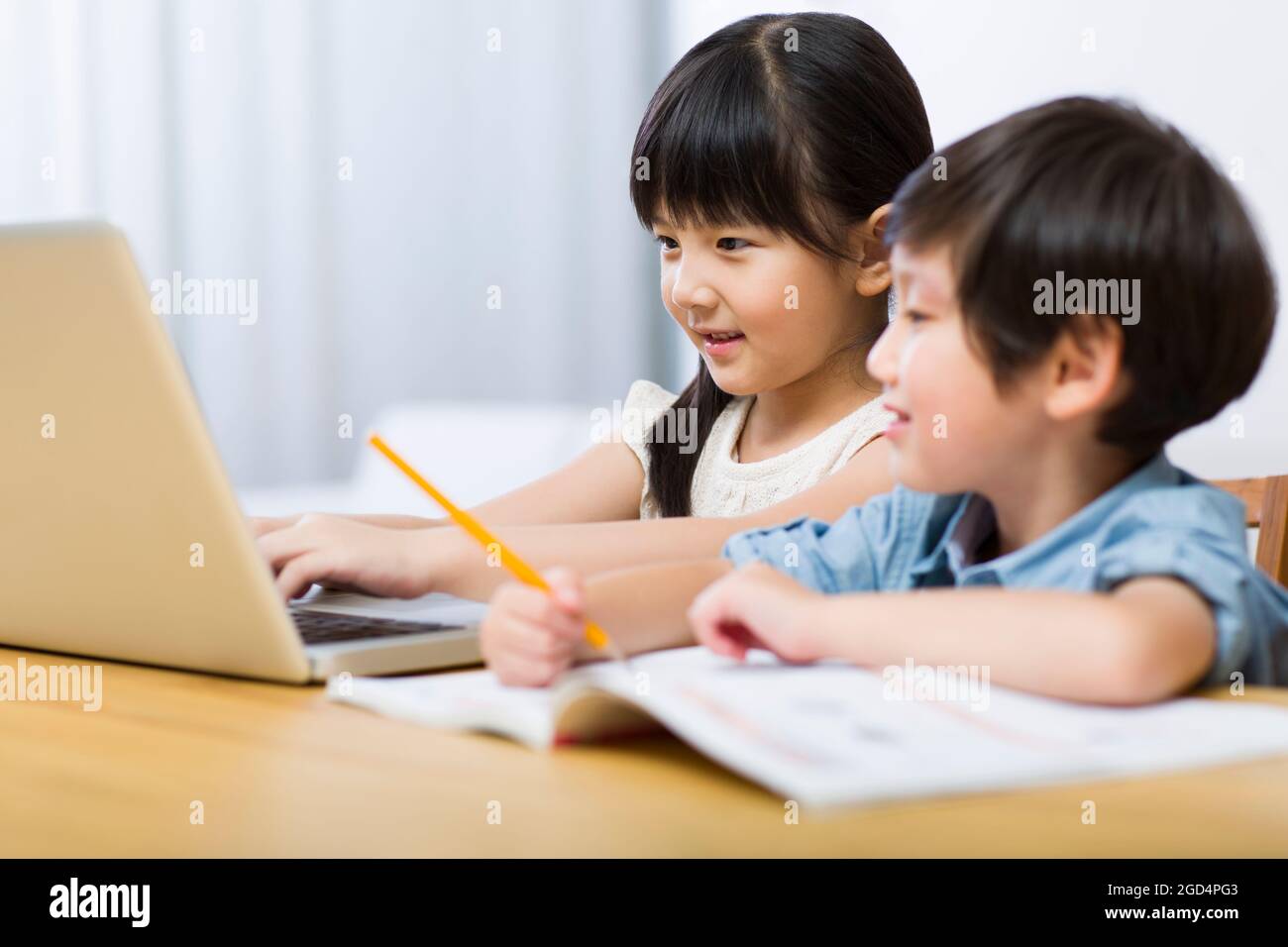 Little boy and girl doing homework Stock Photo - Alamy