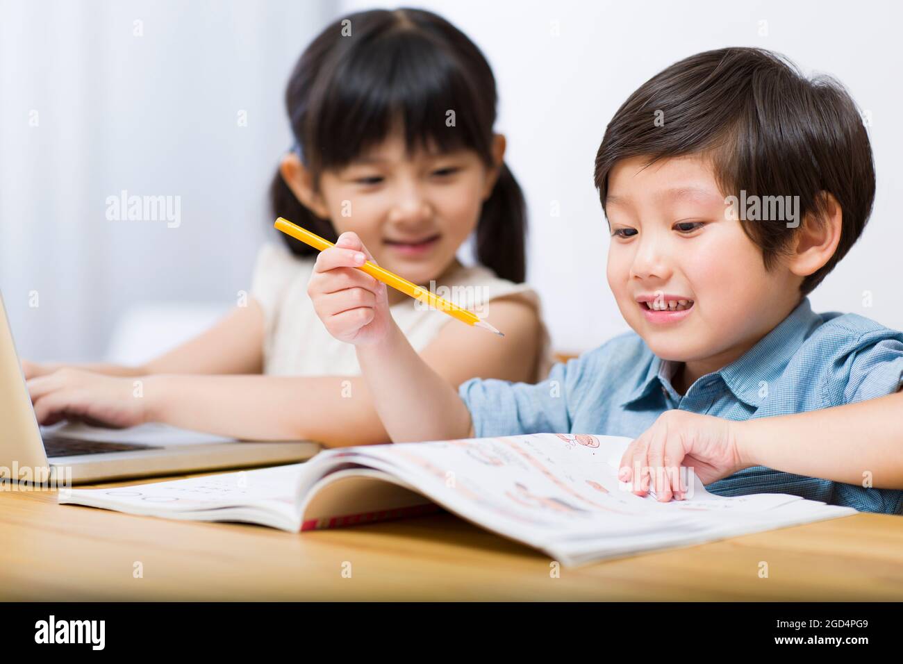 Little boy and girl doing homework Stock Photo - Alamy