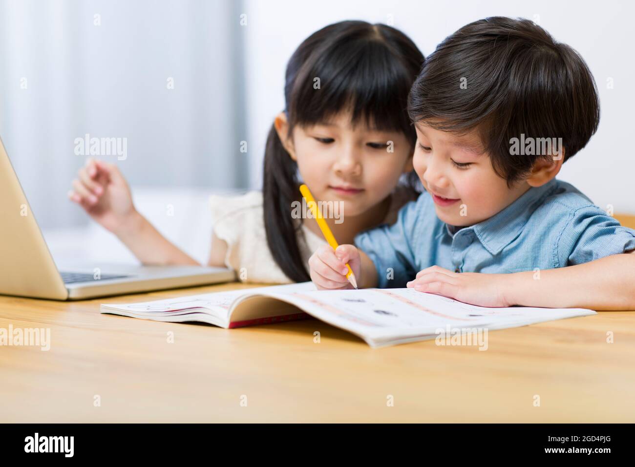 Little boy and girl doing homework Stock Photo - Alamy