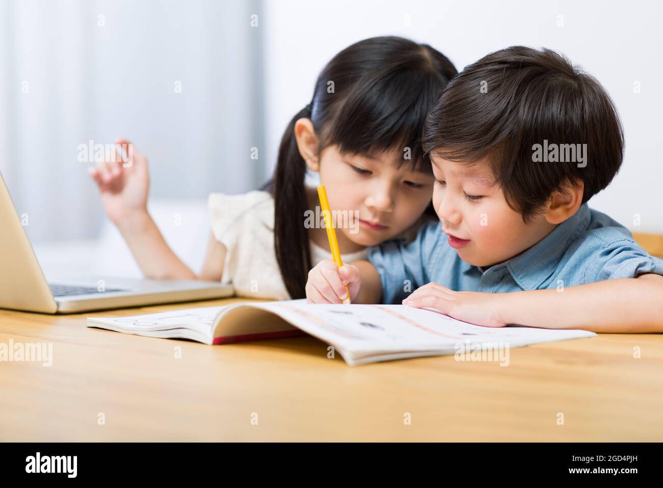 Little boy and girl doing homework Stock Photo - Alamy