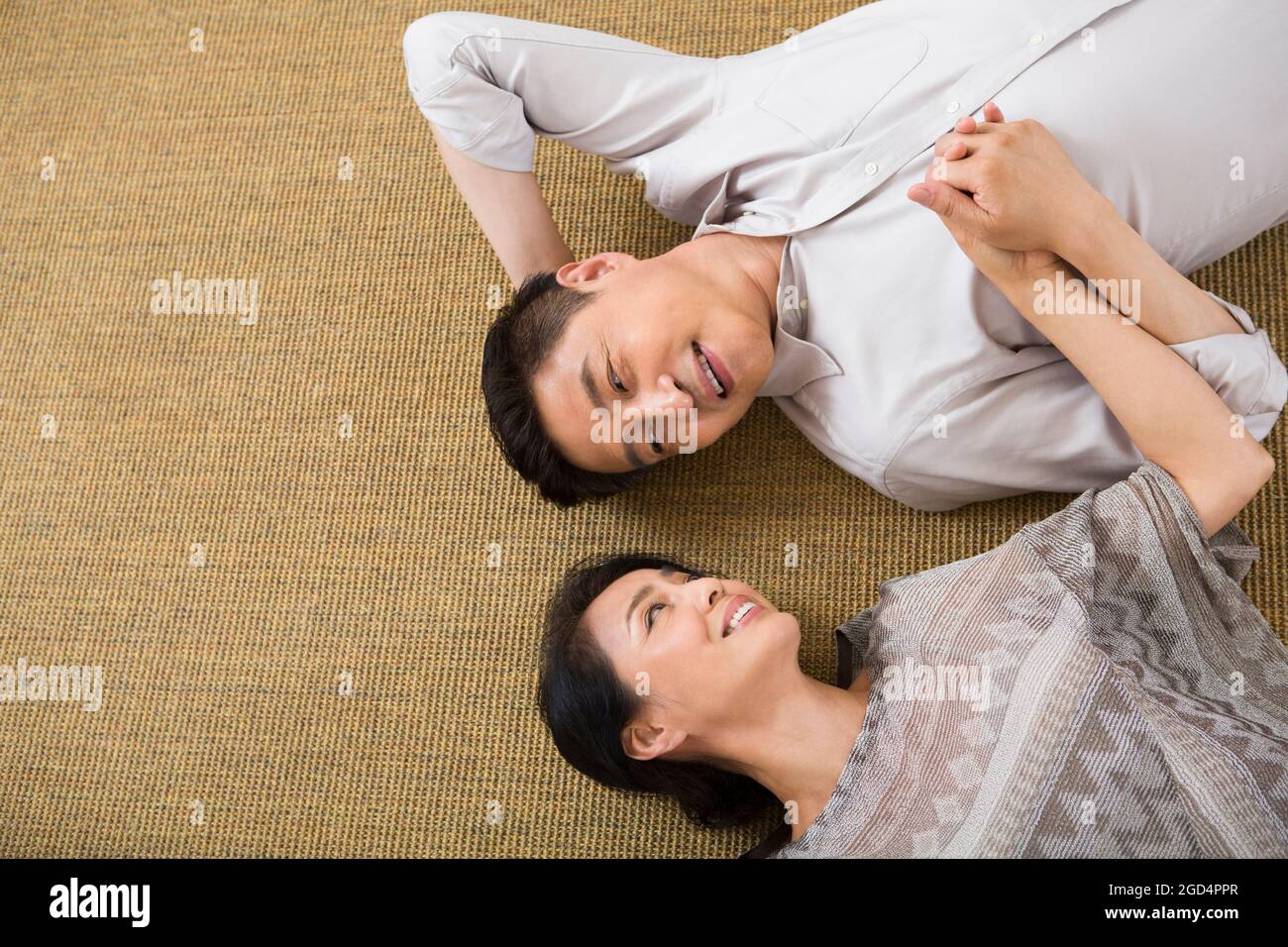 Mature couple resting on floor board Stock Photo - Alamy