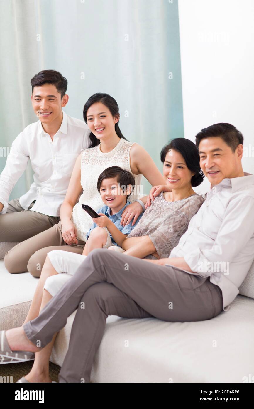Happy big family watching TV at home Stock Photo - Alamy