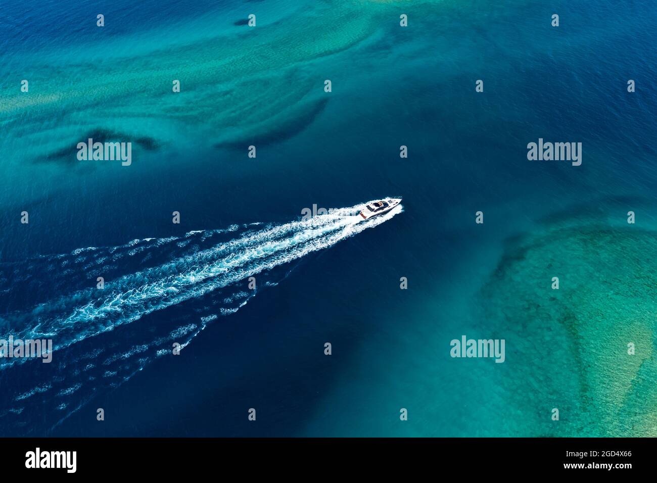 Large speed boat moving at high speed. Top view of a white boat sailing ...