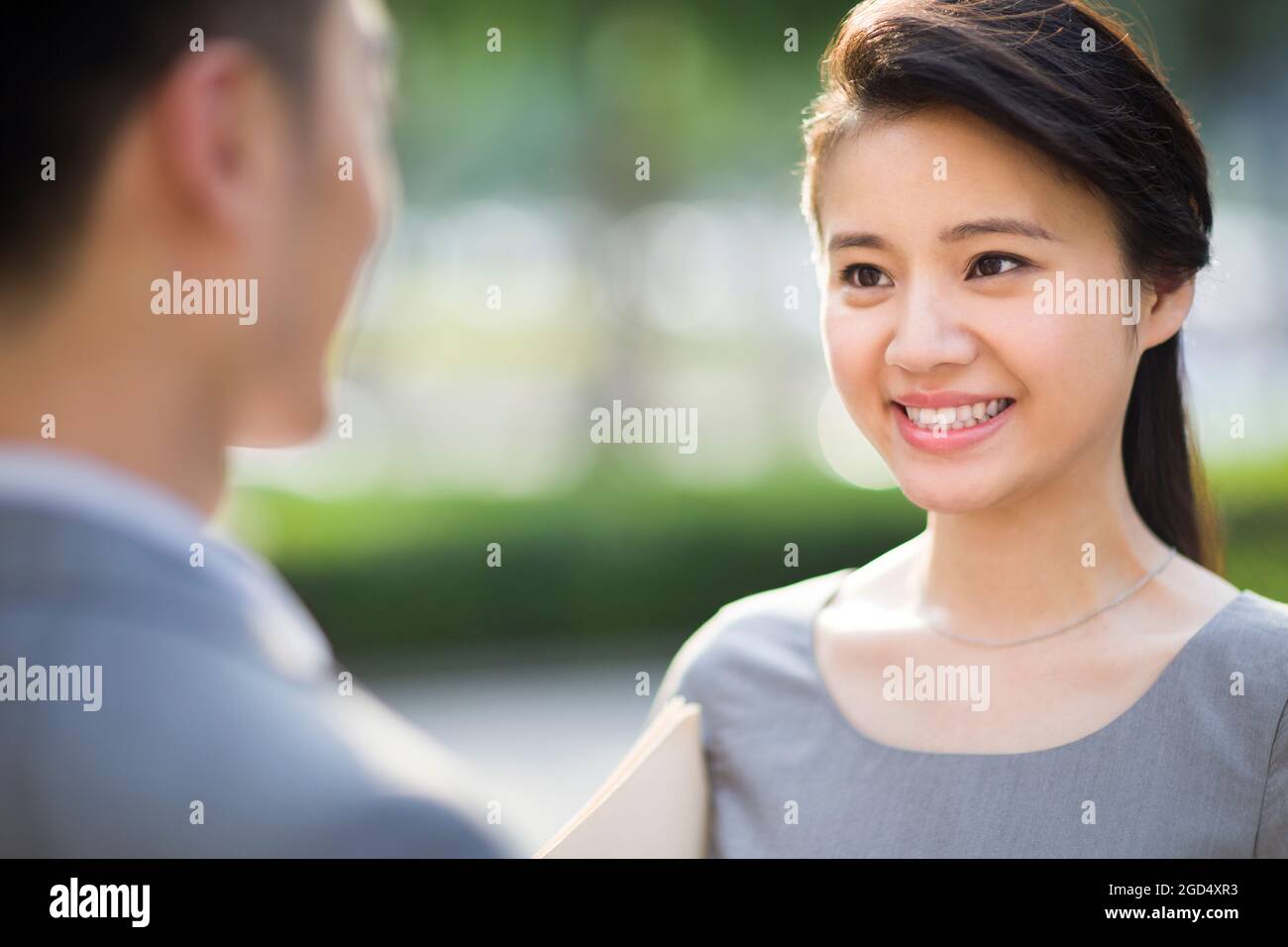 Happy businesspeople face to face talking Stock Photo - Alamy