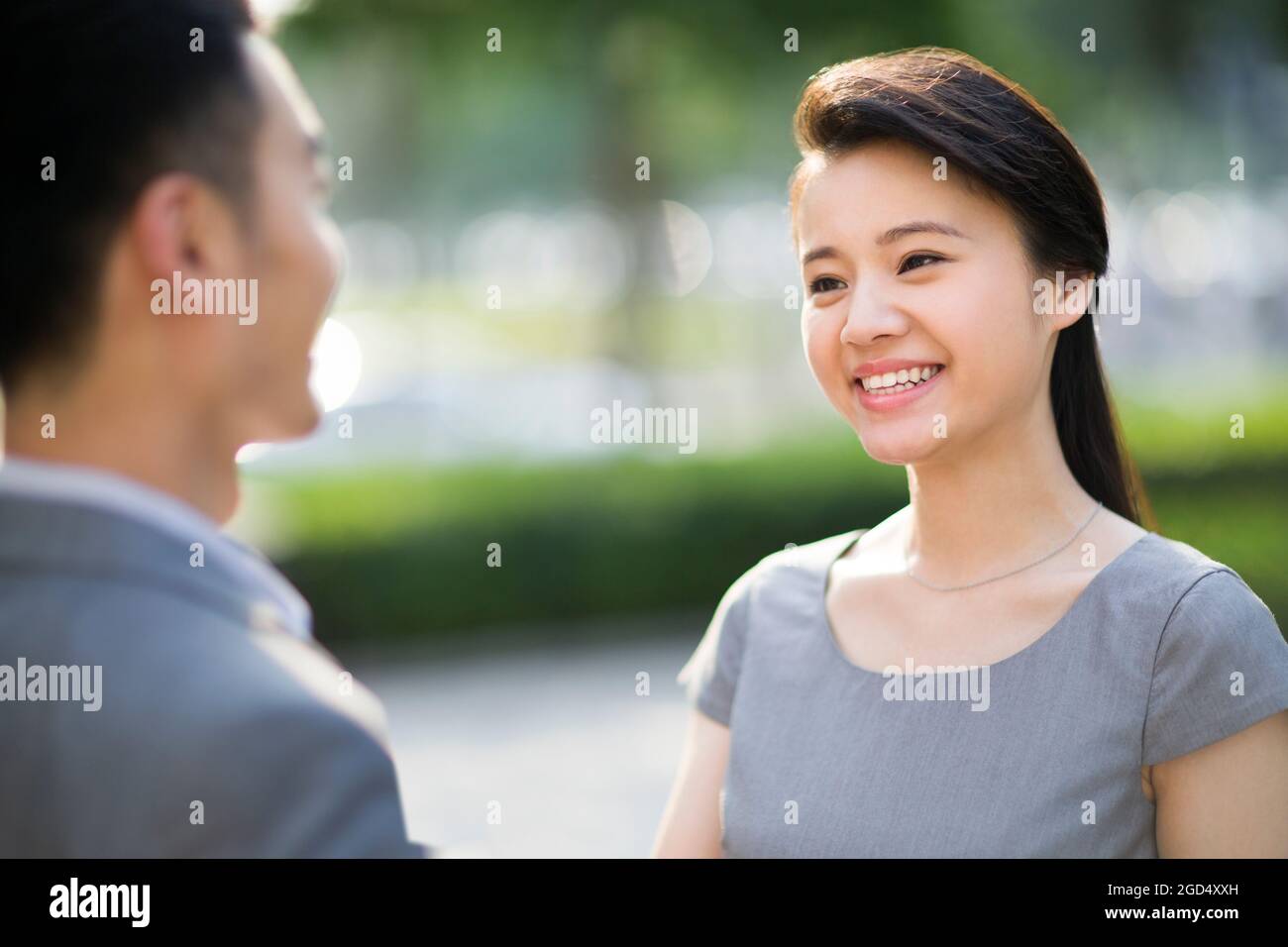 Happy businesspeople face to face talking Stock Photo - Alamy
