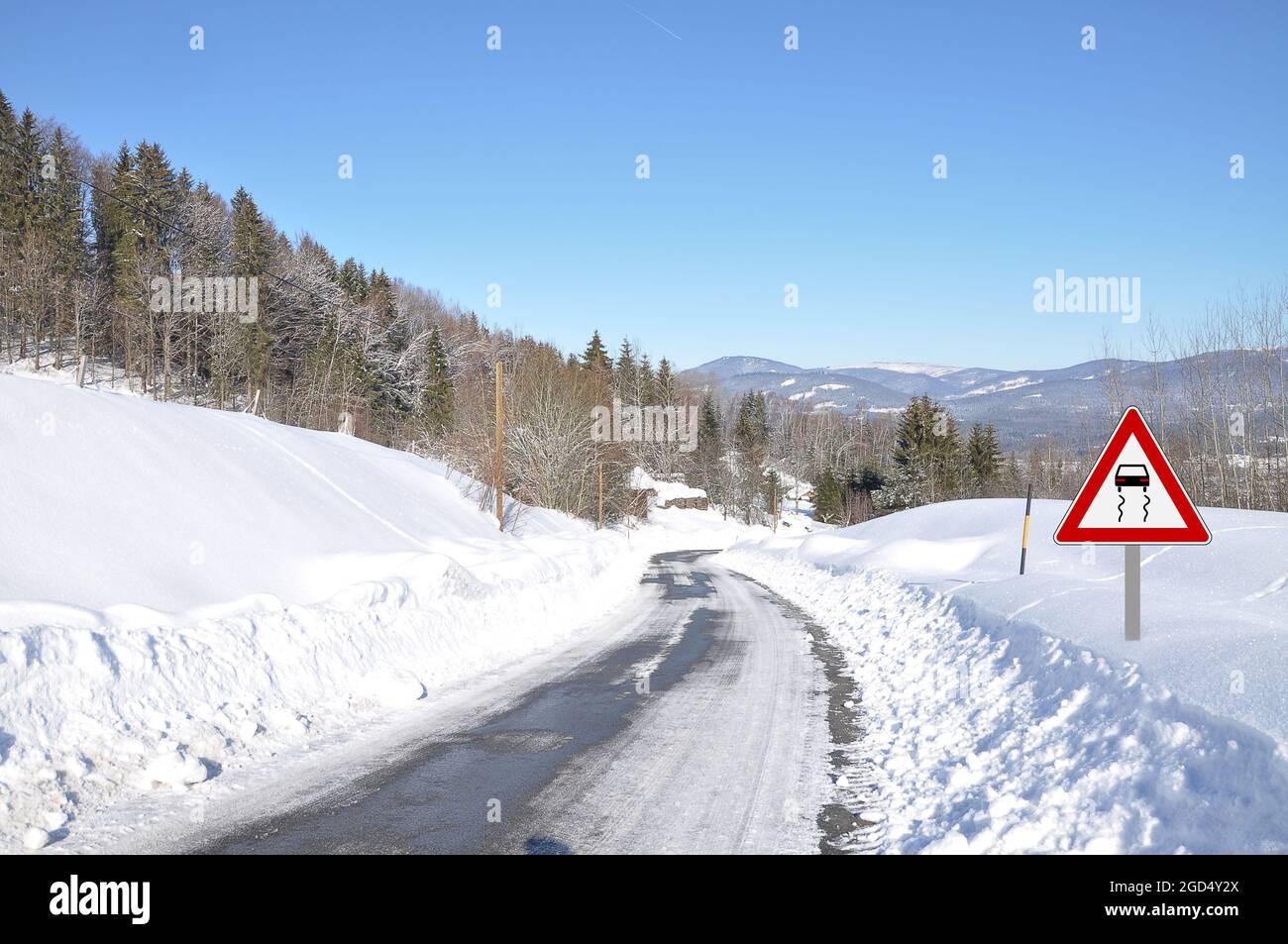 Warning sign at snow-covered road in Bavaria Stock Photo - Alamy