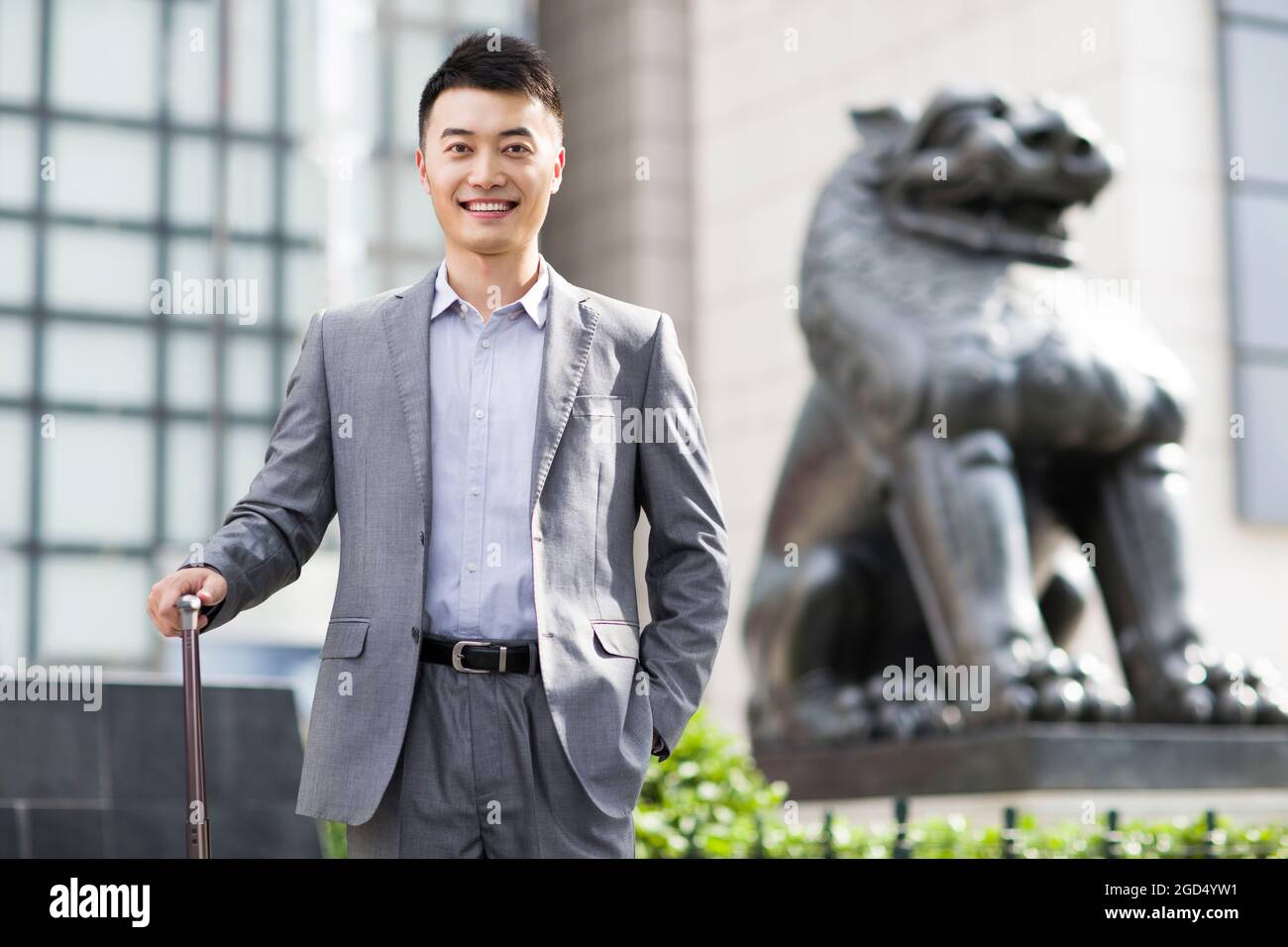 Cheerful businessman outside bank Stock Photo - Alamy