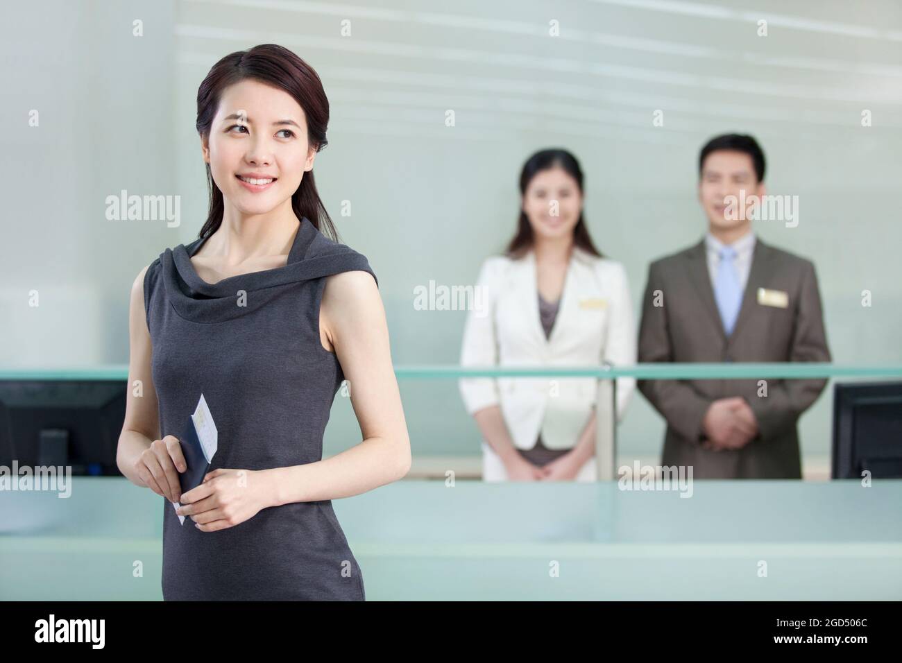 Businesswoman at reception desk Stock Photo - Alamy
