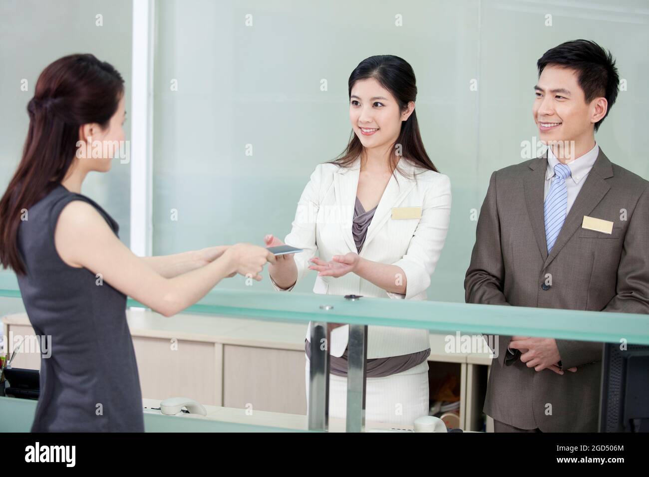 Businesswoman check in at reception desk Stock Photo - Alamy