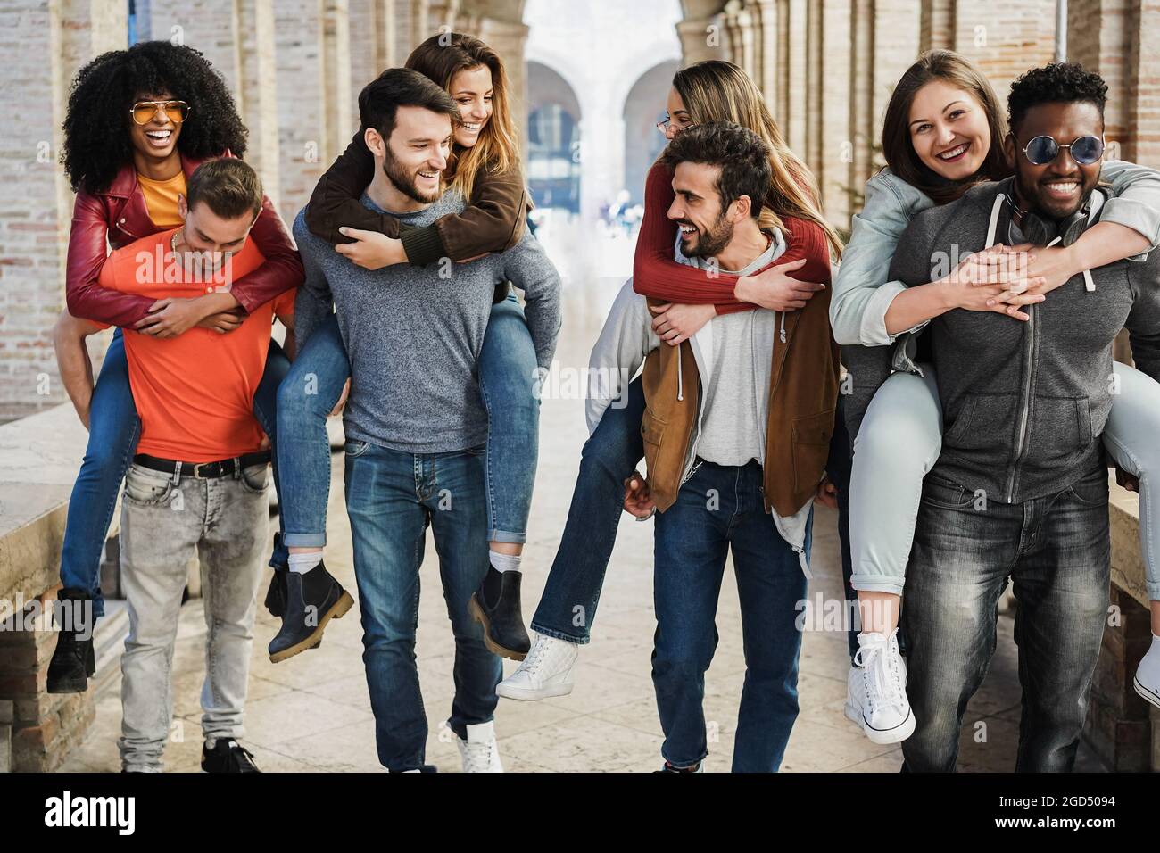 Young multiracial people having fun outdoor in the city - Focus on ...