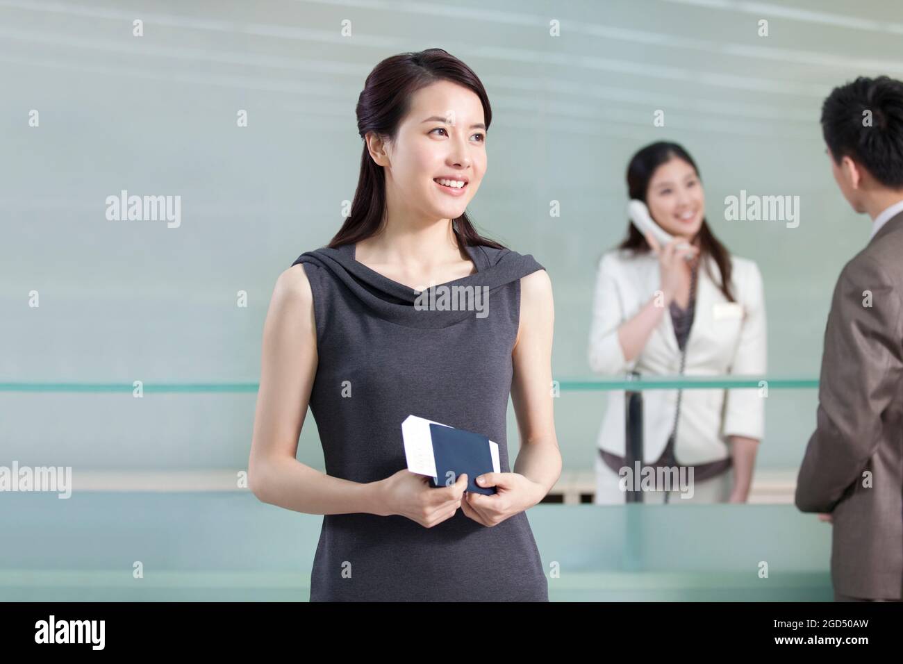 Businesswoman at reception desk Stock Photo - Alamy