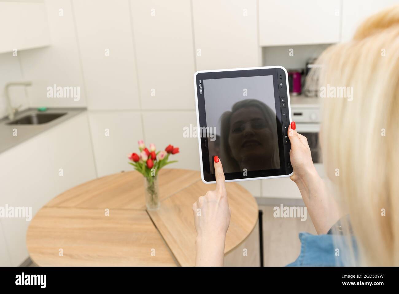 Woman monitoring cameras Live view on the tablets display. Home ...