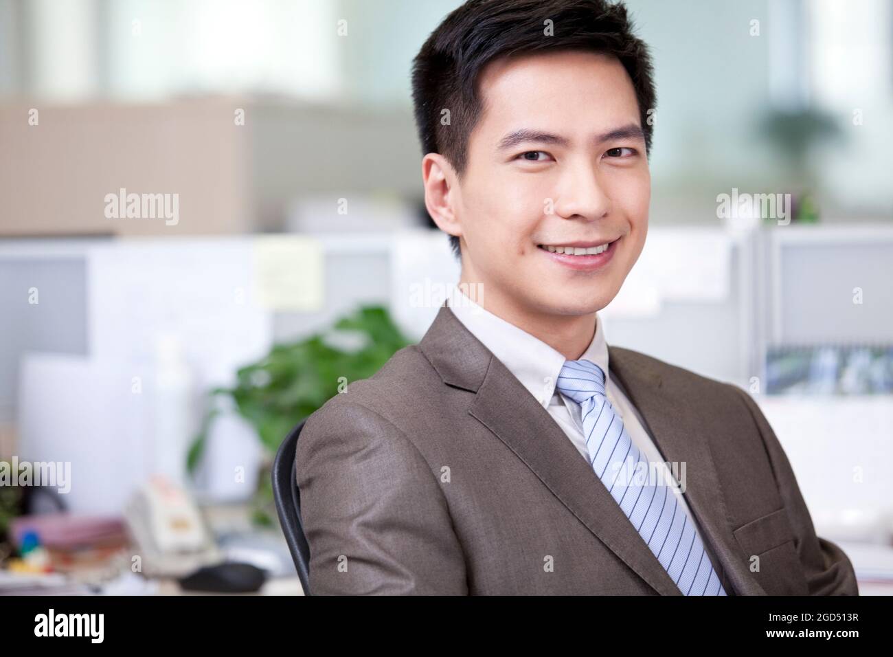 Portrait of happy businessman in office Stock Photo - Alamy