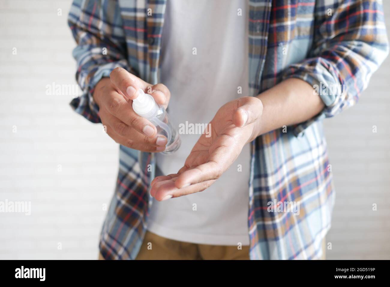 young man hand using hand sanitizer spray Stock Photo - Alamy