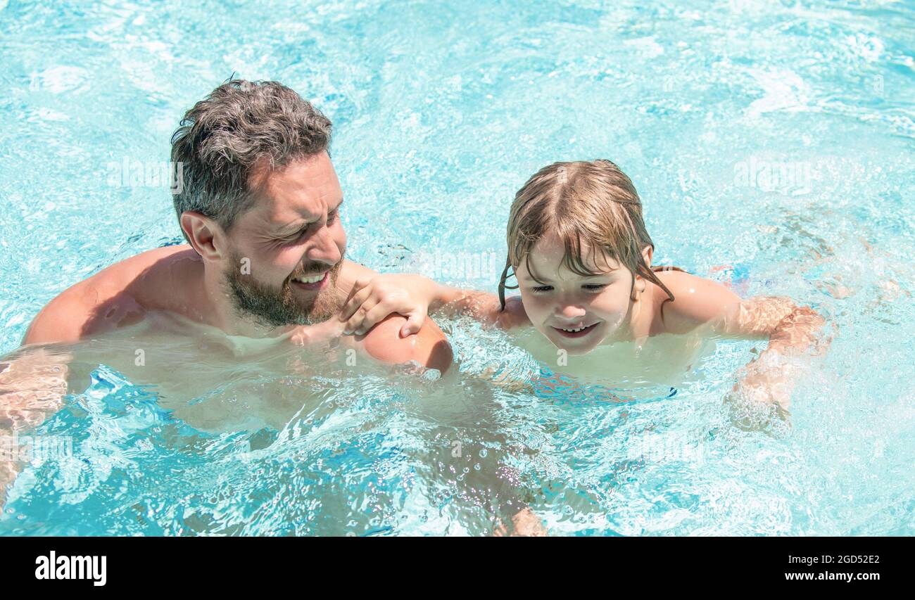 happy family of father and small boy having fun in summer swimming pool ...