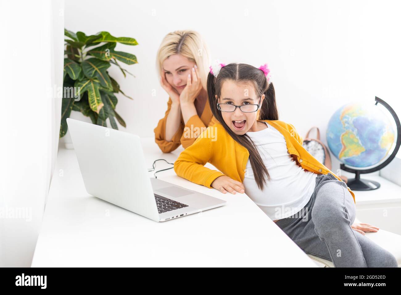 Online education of children. Mother and daughter of preschool watching ...