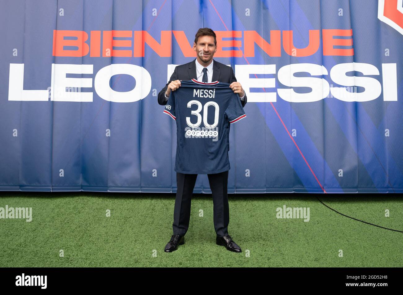 Argentinian football player Lionel Messi holds-up his number 30 shirt ...