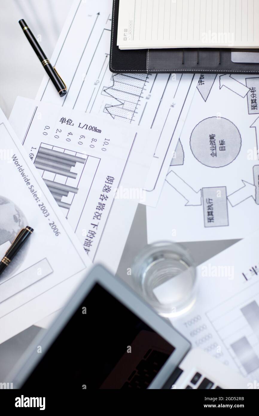 Business charts on office desk Stock Photo - Alamy