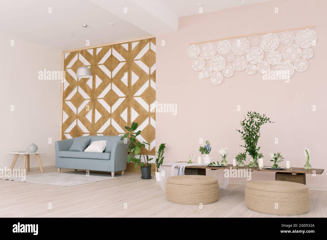 Stylish interior with designer wood wall and blue sofa sofa, coffee ...