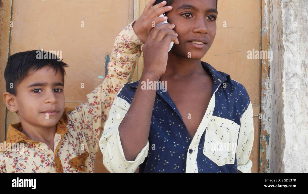 Two boys talking street hi-res stock photography and images - Alamy