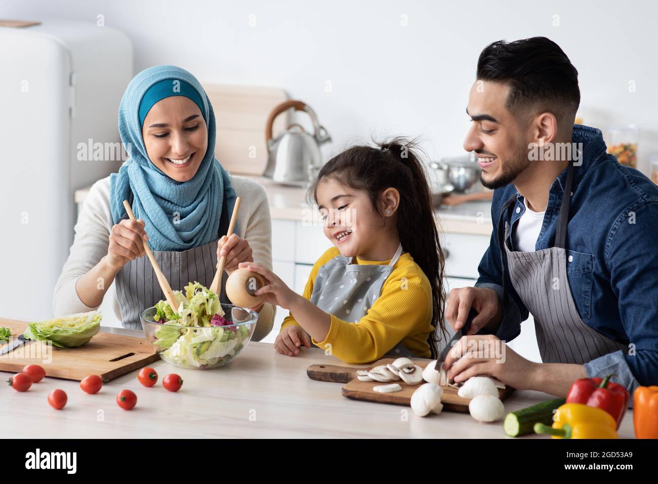 Healthy Lunch. Cheerful Muslim Family Of Three Cooking Vegetarian Meal ...