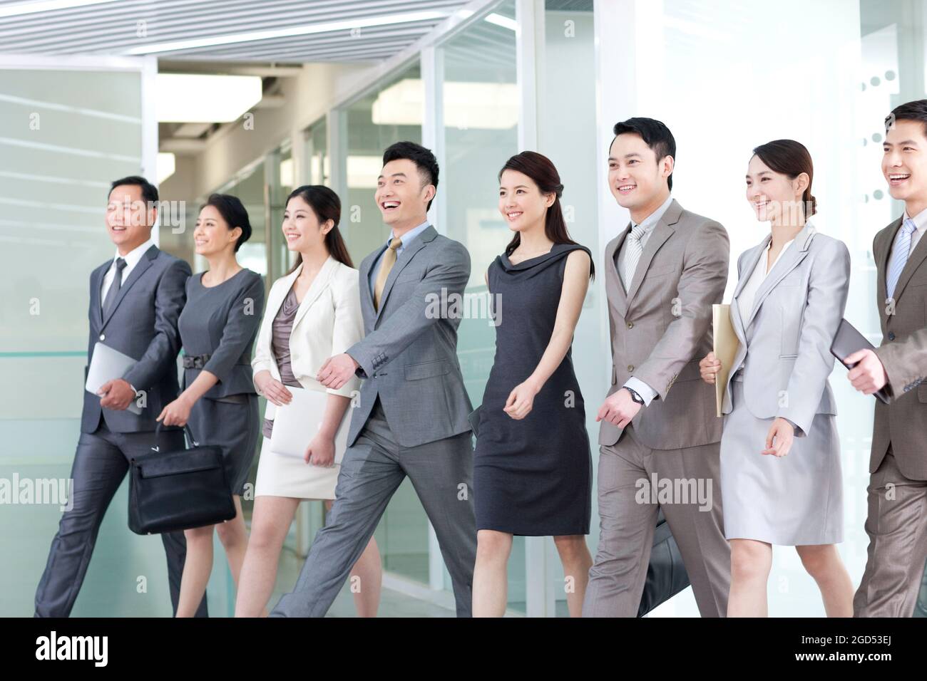 Confident business team walking forward Stock Photo - Alamy