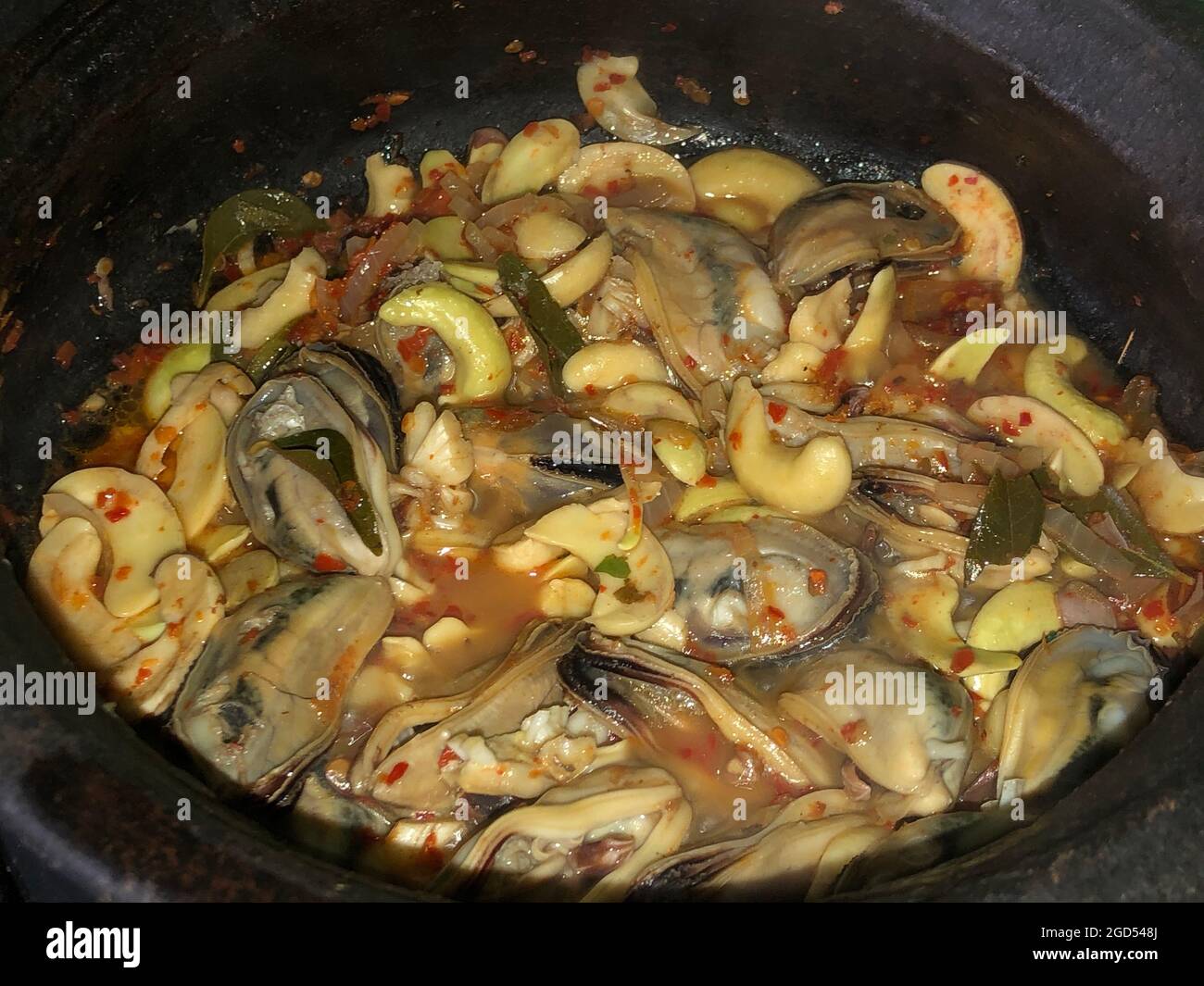 Closeup view of fresh frozen mussel meat, cooked mussel curry, mussel ...
