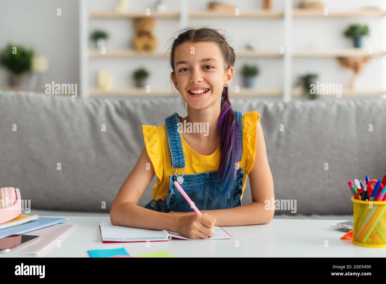 Academic Concept. Smiling school girl with colorful dyed hair sitting ...