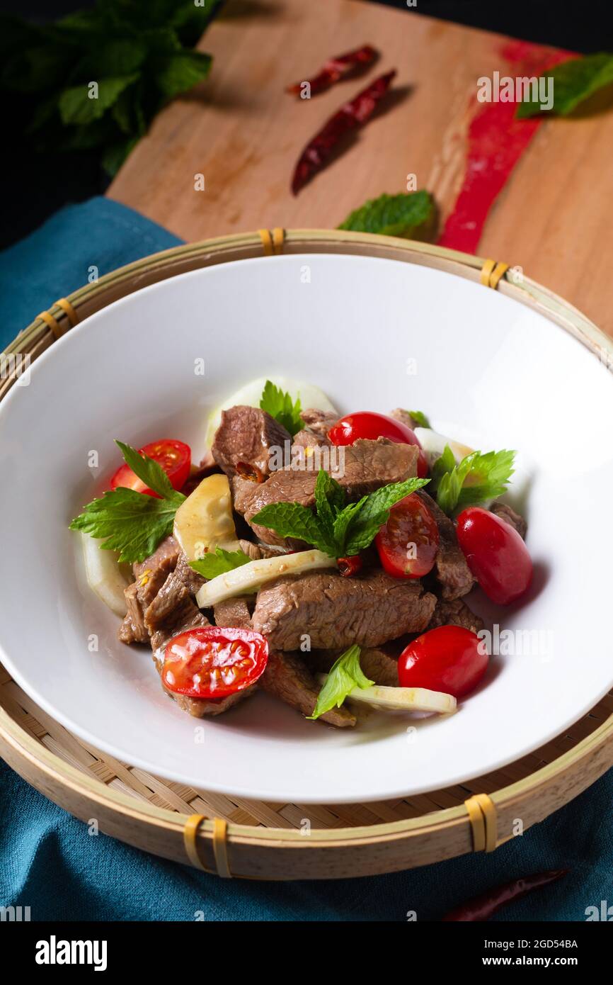 Food concept Thai spicy beef salad Yum Nua yang on wooden board with ...