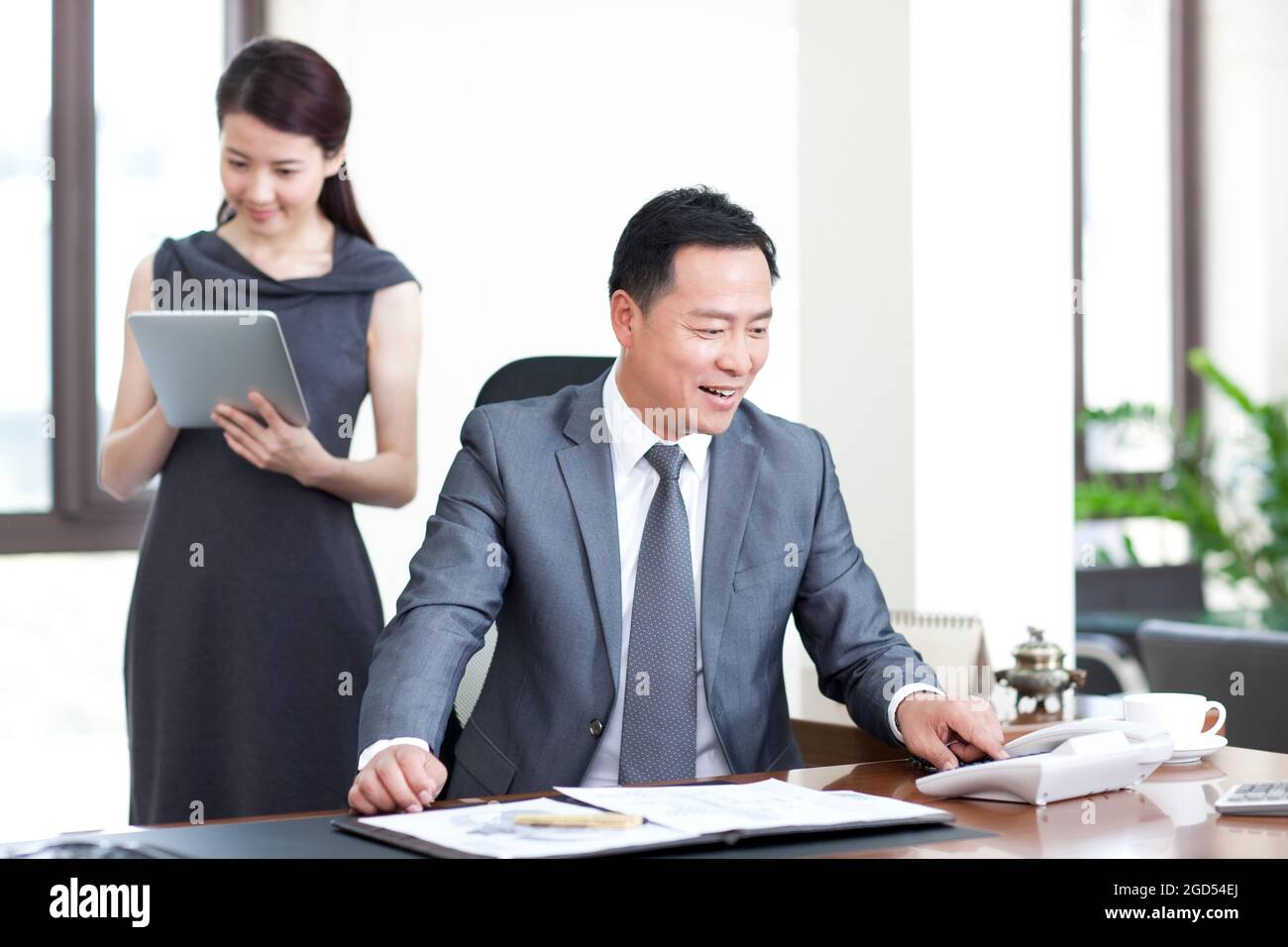 Happy business colleagues at work Stock Photo - Alamy