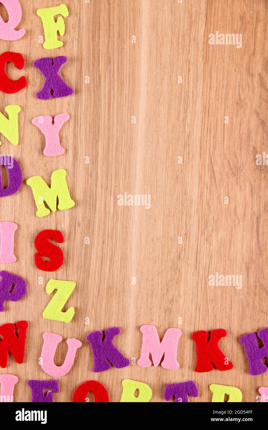 English alphabet on wooden background Stock Photo - Alamy