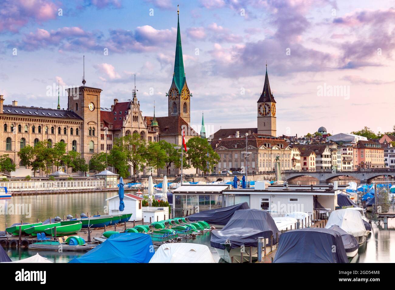 View of the city embankment and the clock tower at sunset. Zurich ...