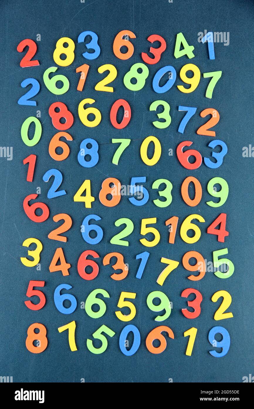 Colorful numbers on school desk background Stock Photo - Alamy
