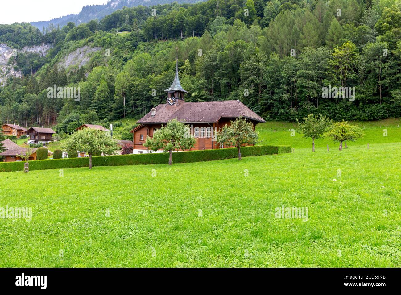 Church in the traditional Swiss village of Iseltwald on the famous lake ...