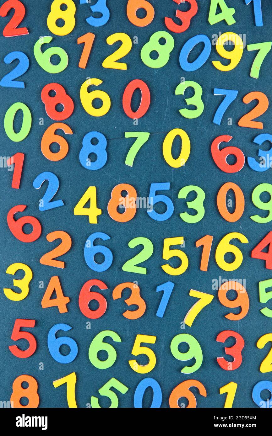 Colorful numbers on school desk background Stock Photo - Alamy
