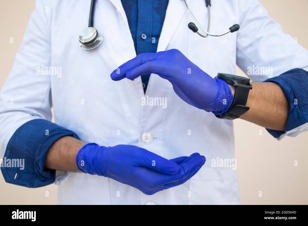 Doctor hands in medical gloves showing sign Stock Photo - Alamy