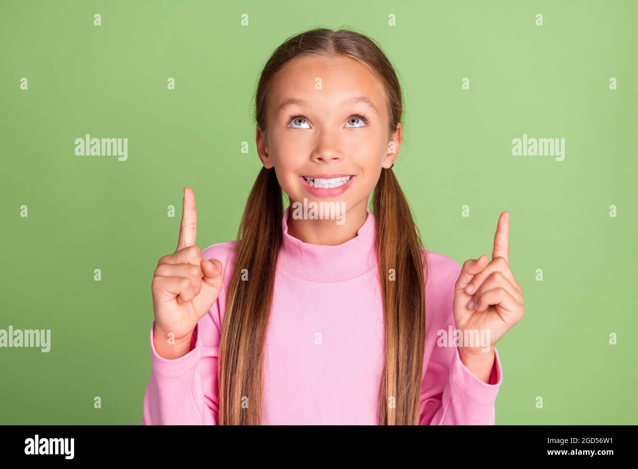 Portrait of attractive cheerful girl showing up copy space ad advert ...