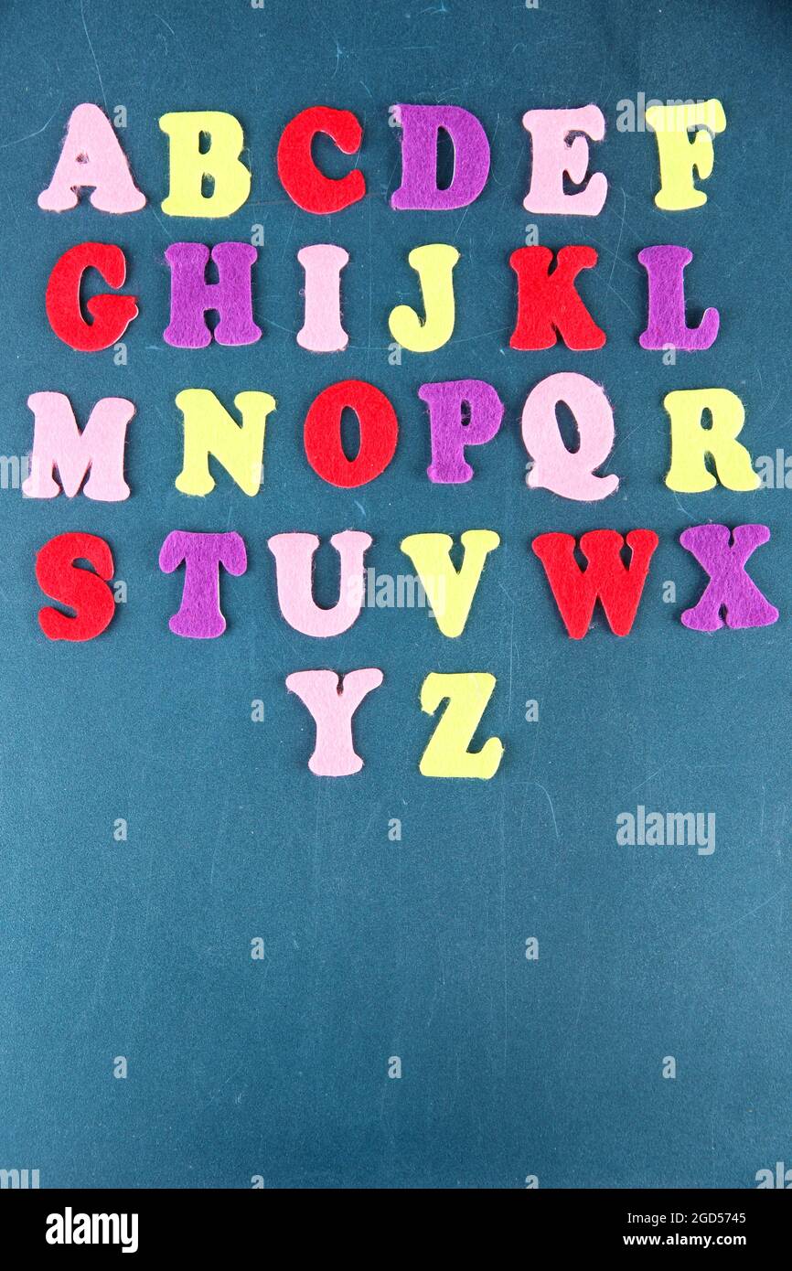 English alphabet on school desk background Stock Photo - Alamy