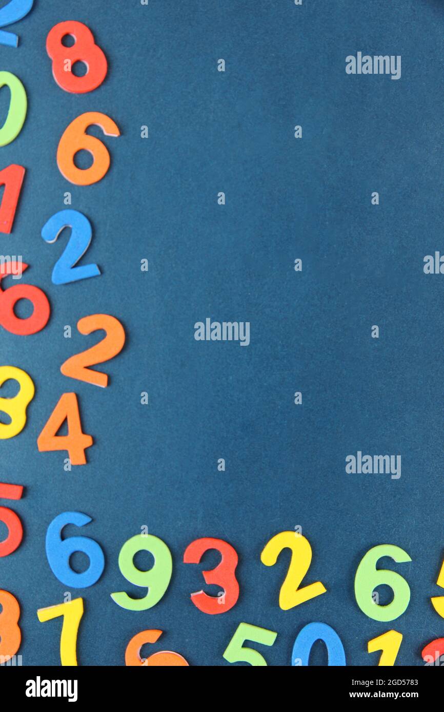 Colorful numbers on school desk background Stock Photo - Alamy