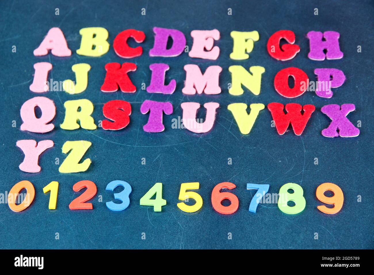 English alphabet and numbers on school desk background Stock Photo - Alamy