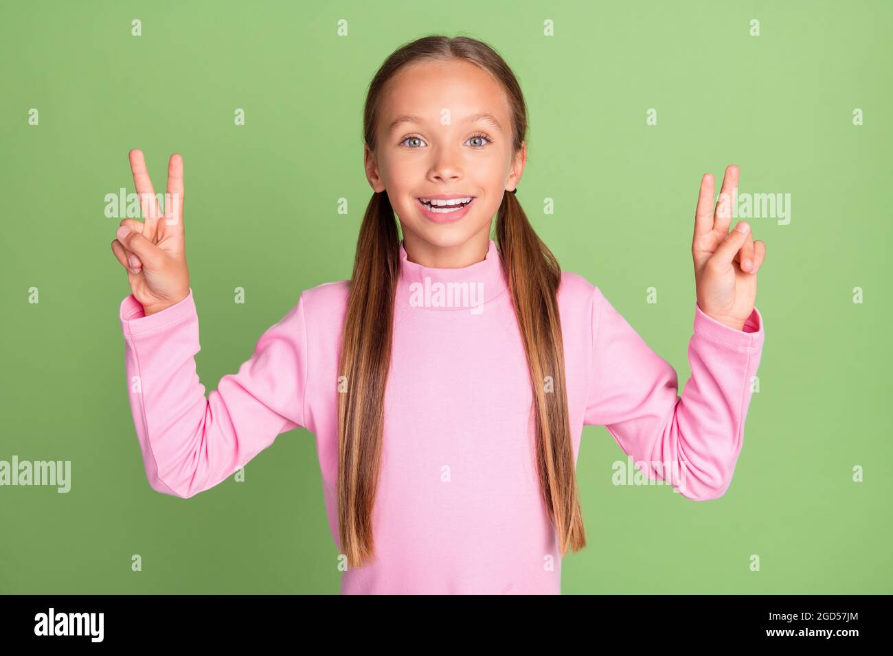 Portrait of attractive cheerful girl showing double v-sign good mood ...