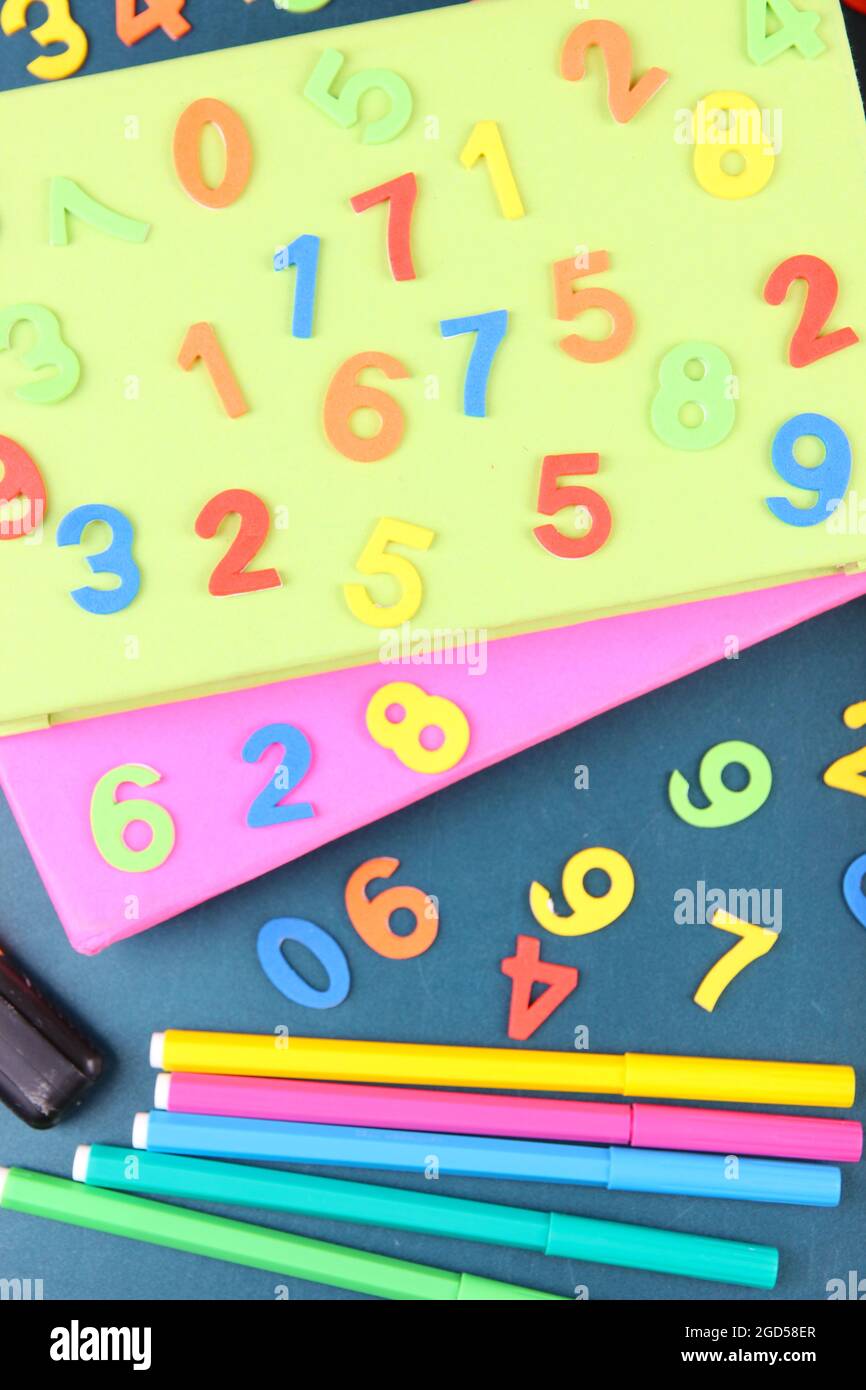 Colorful numbers, books and markers on school desk background Stock ...