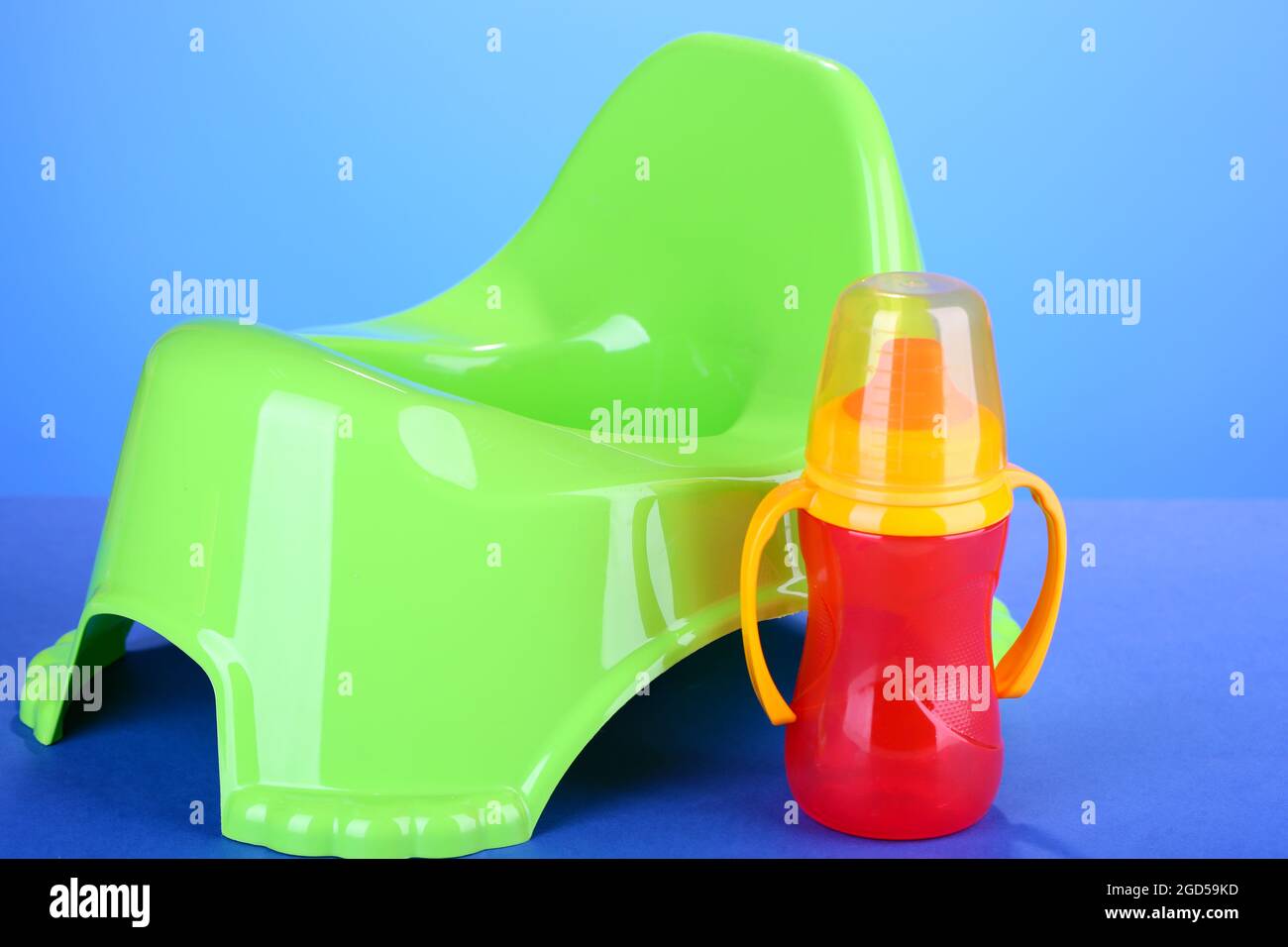 Green potty on color background Stock Photo - Alamy