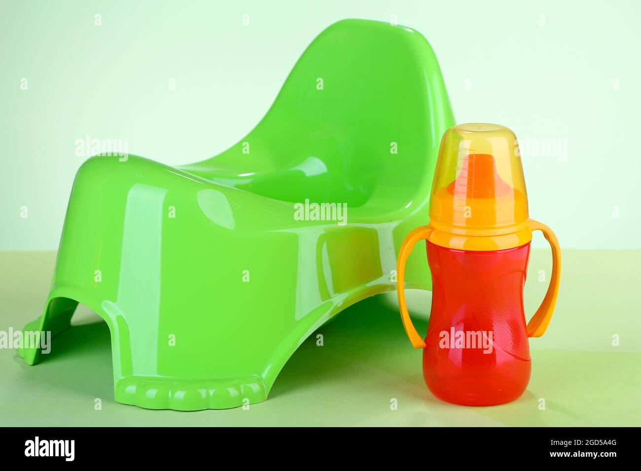 Green potty on color background Stock Photo - Alamy