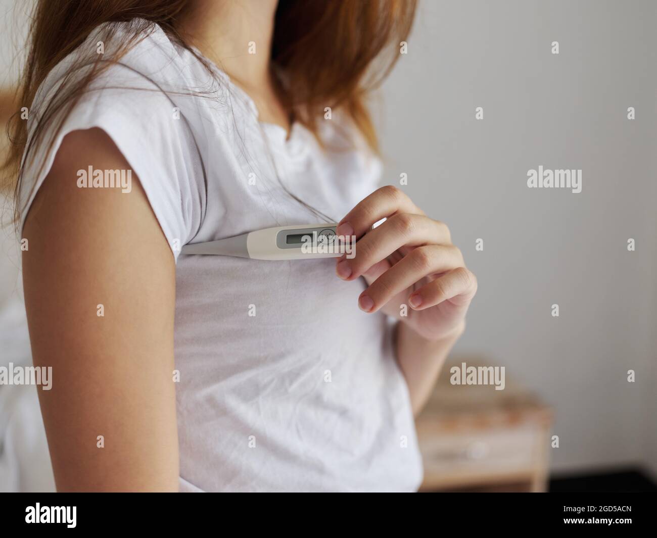 woman checks temperature with thermometer armpit bedroom Stock Photo ...