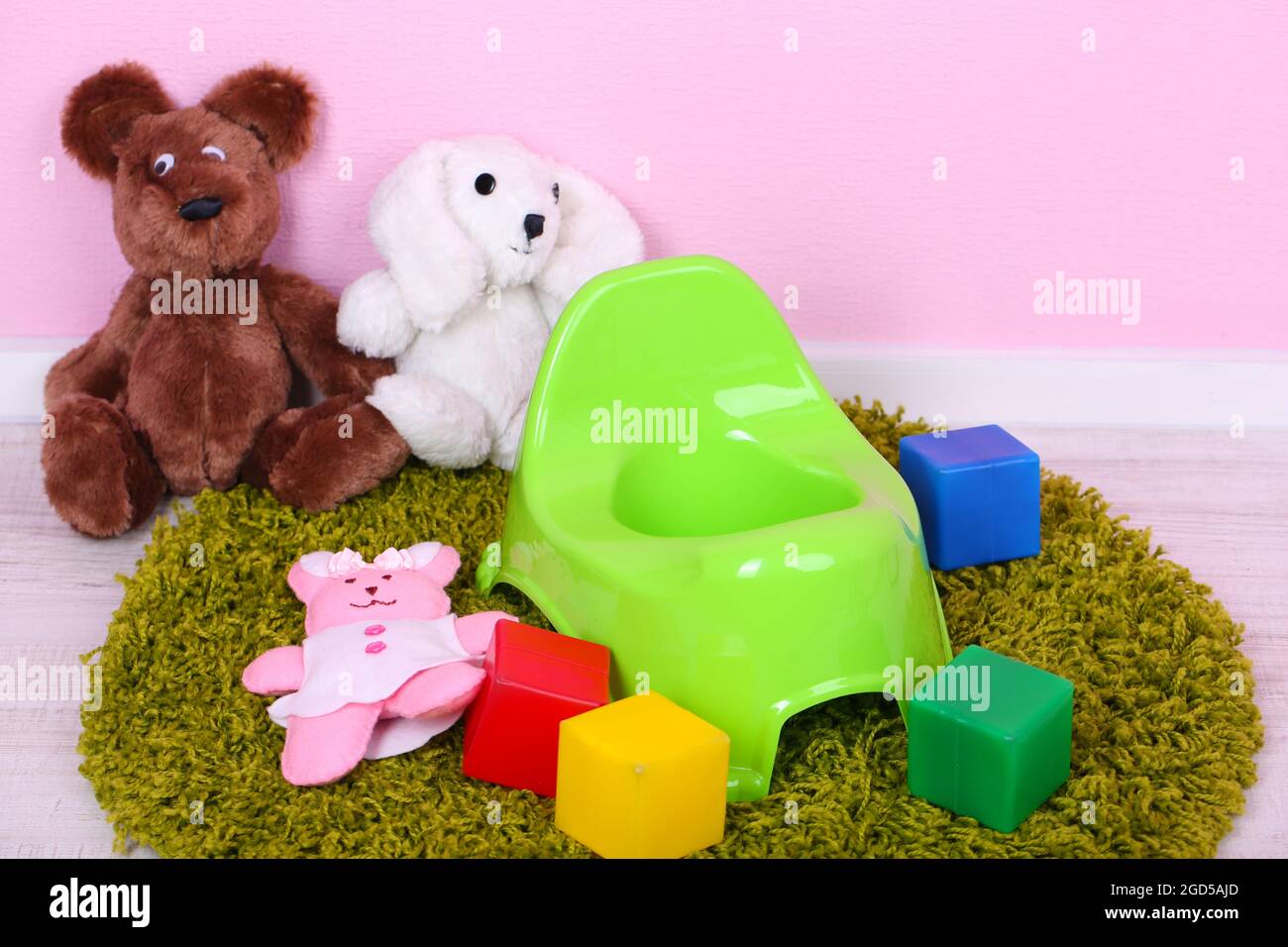 Green potty on home interior background Stock Photo - Alamy