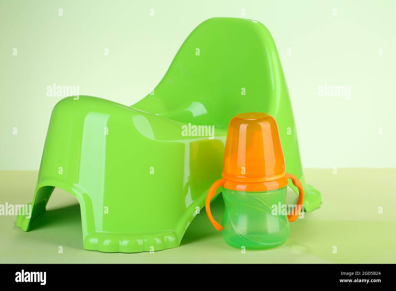 Green potty on color background Stock Photo - Alamy