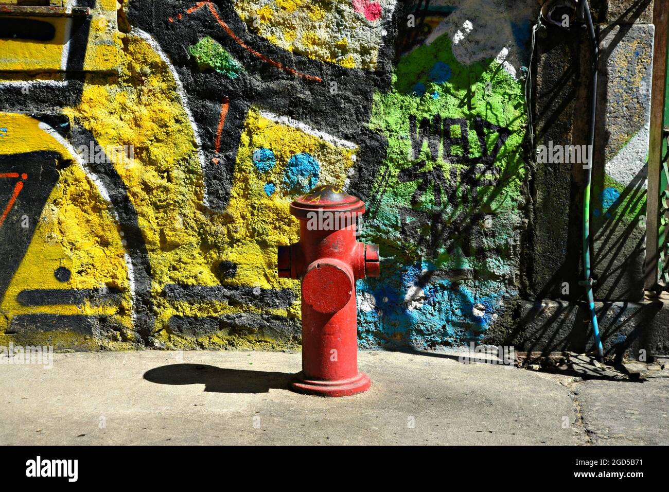Red fire hydrant against a graffiti wall in Santa Teresa, Rio de ...